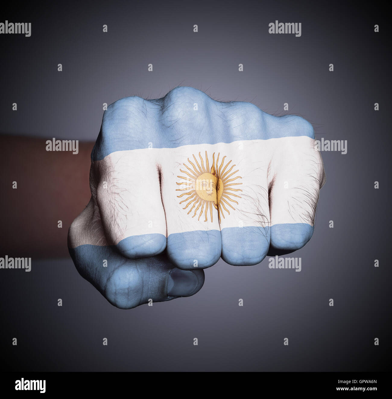 Front view of punching fist on gray background Stock Photo - Alamy