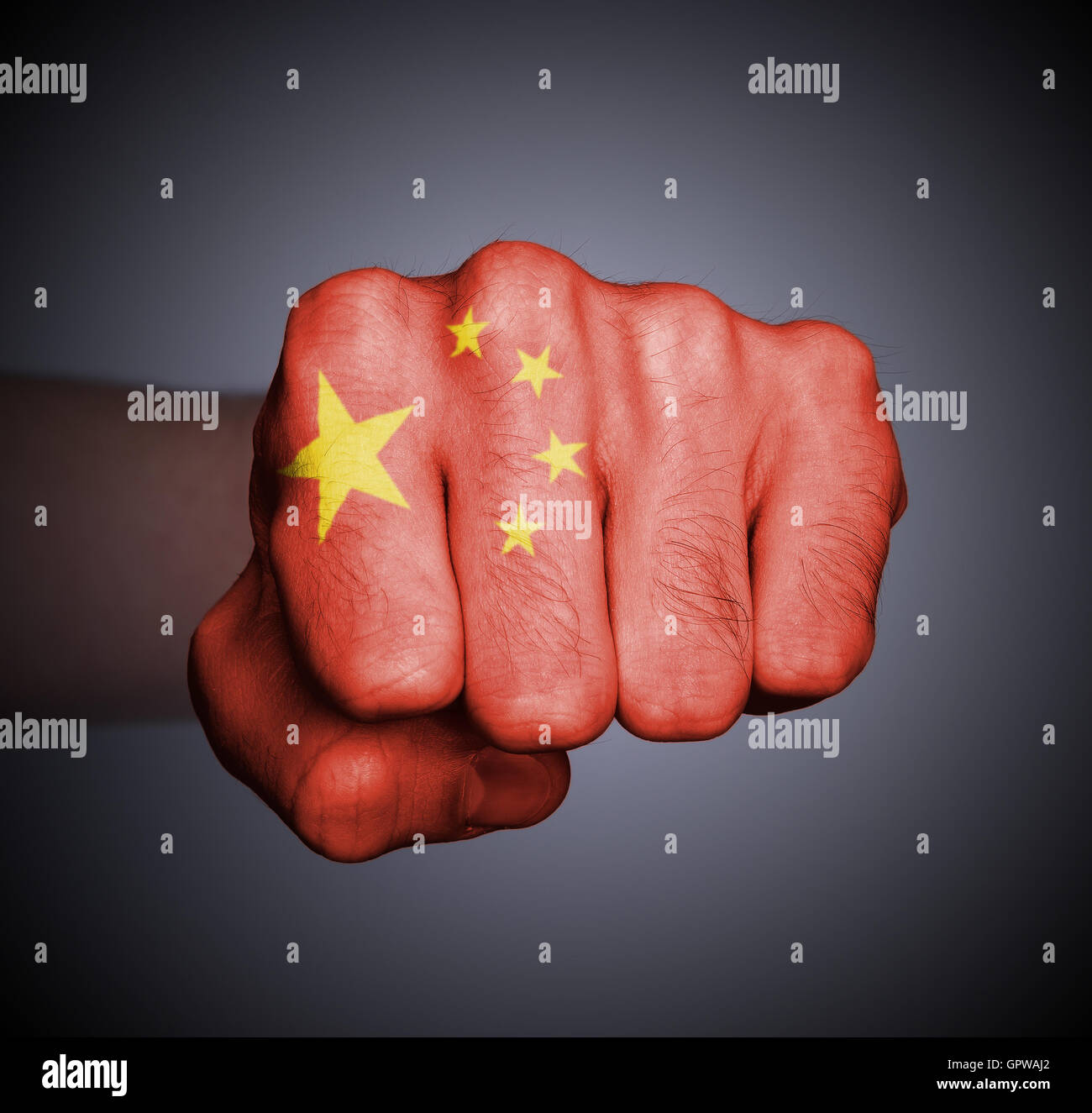 Front view of punching fist on gray background Stock Photo - Alamy