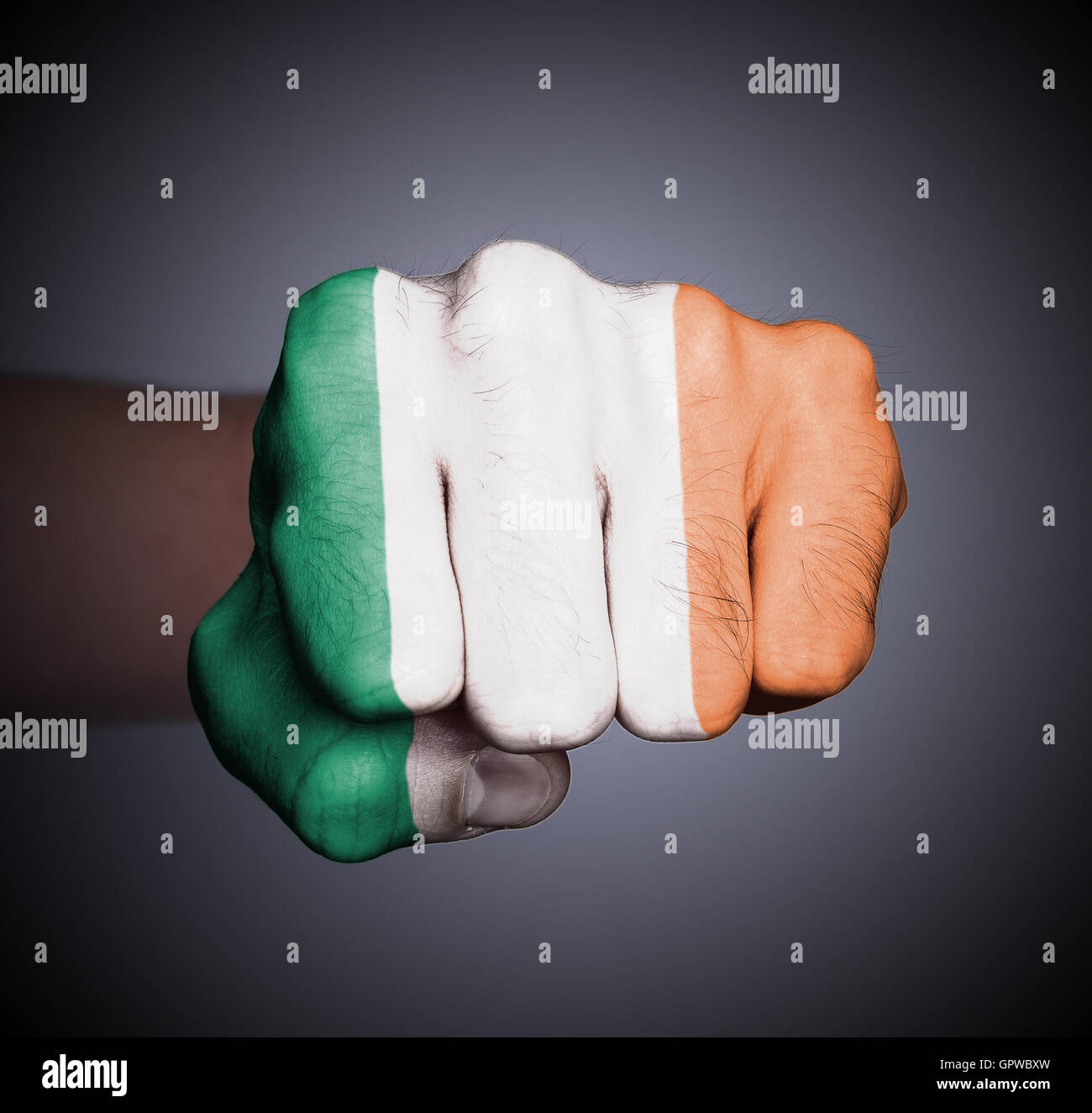 Front view of punching fist on gray background Stock Photo - Alamy