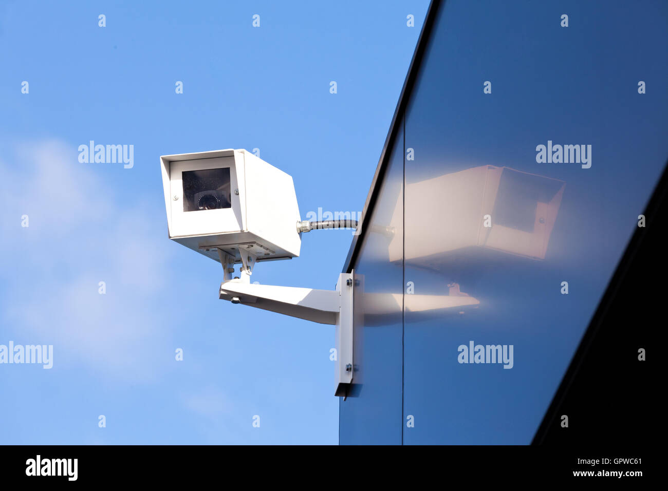 Security camera reflected on shiny building facade Stock Photo - Alamy