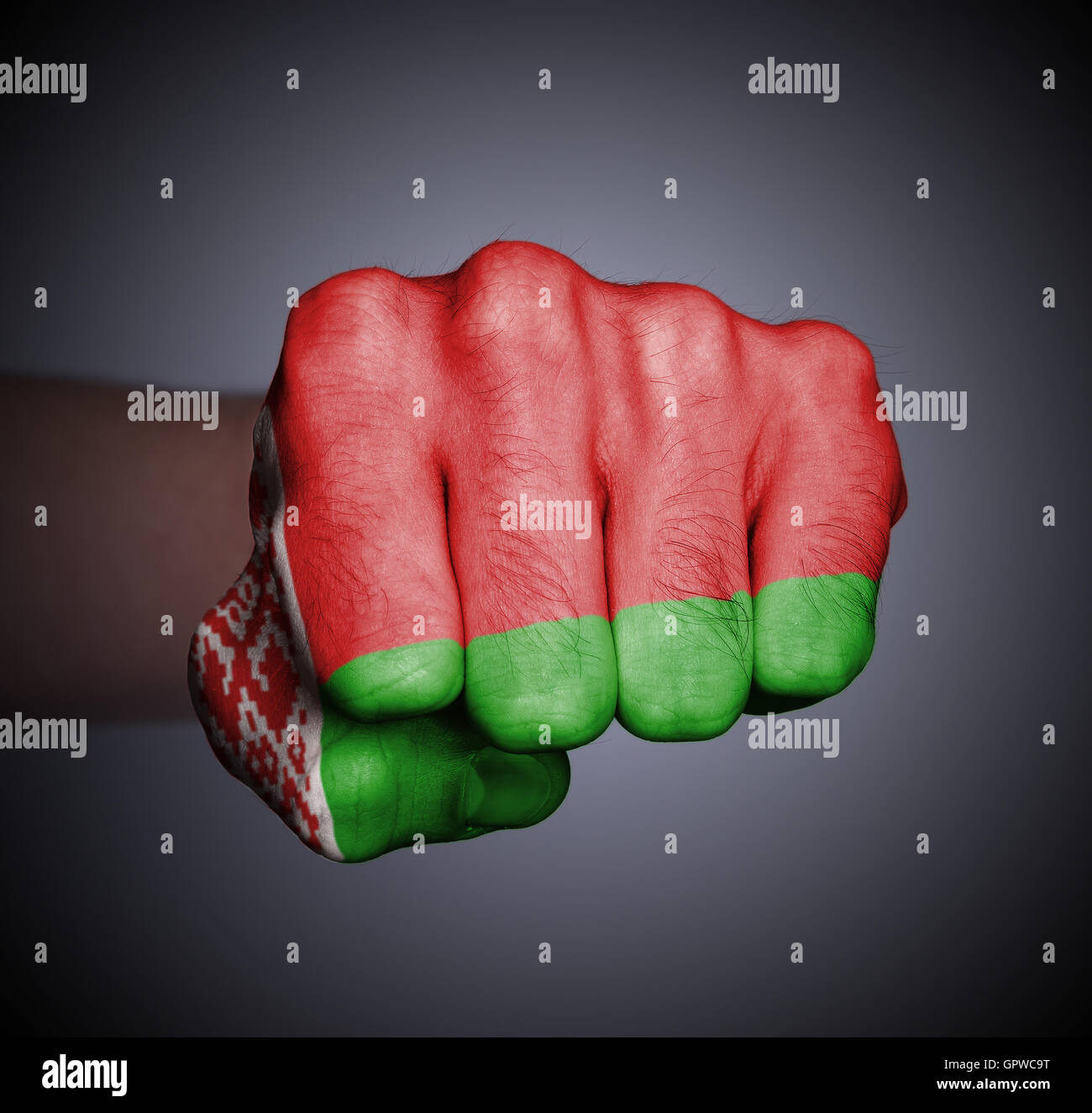 Front view of punching fist on gray background Stock Photo - Alamy