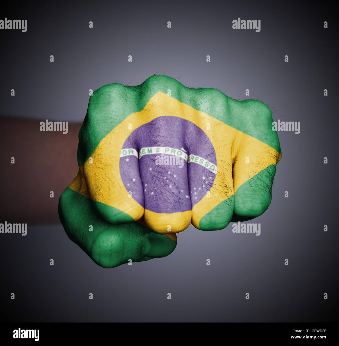 Front view of punching fist on gray background Stock Photo - Alamy