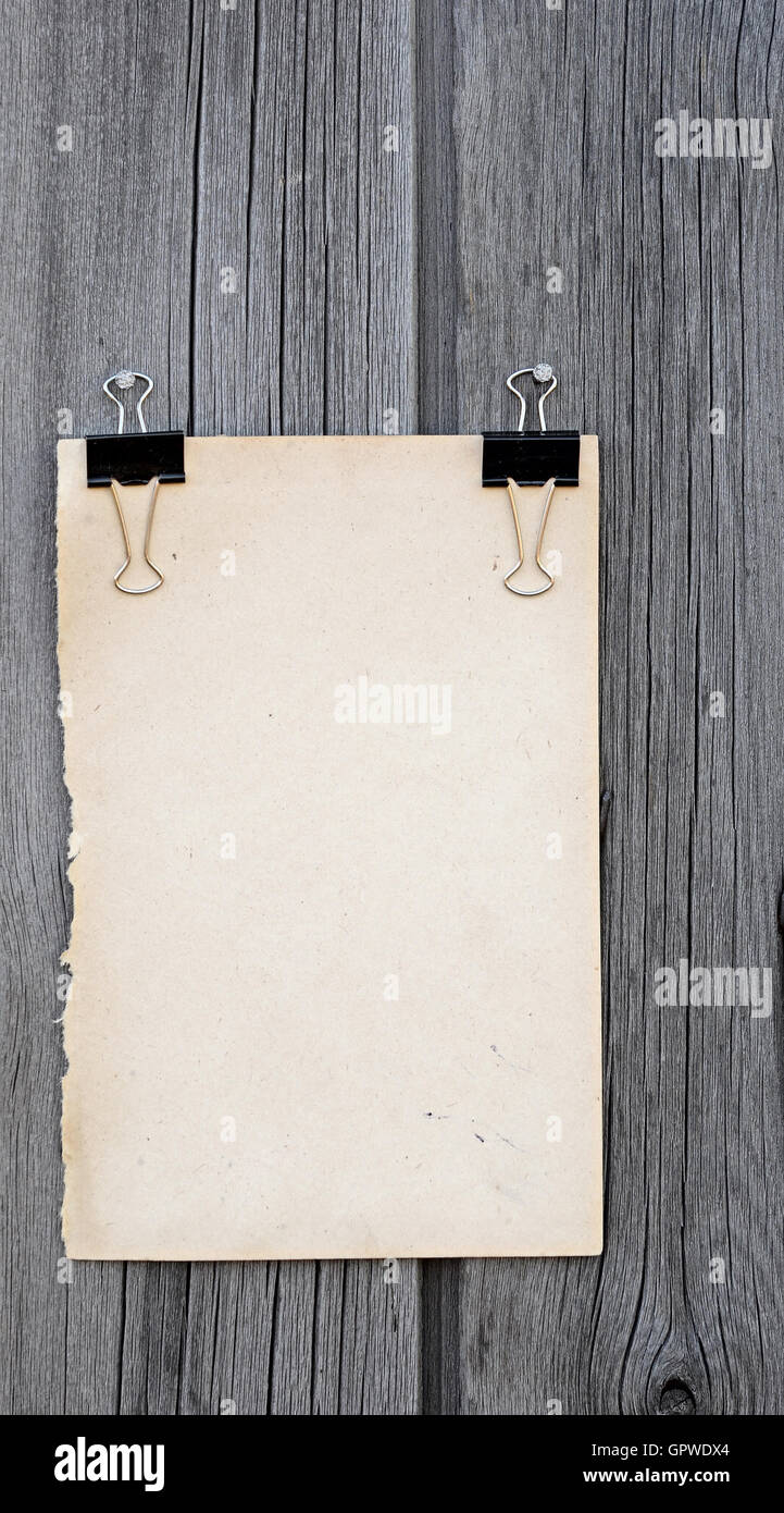 black clip and old blank note paper hang on wood panel Stock Photo - Alamy