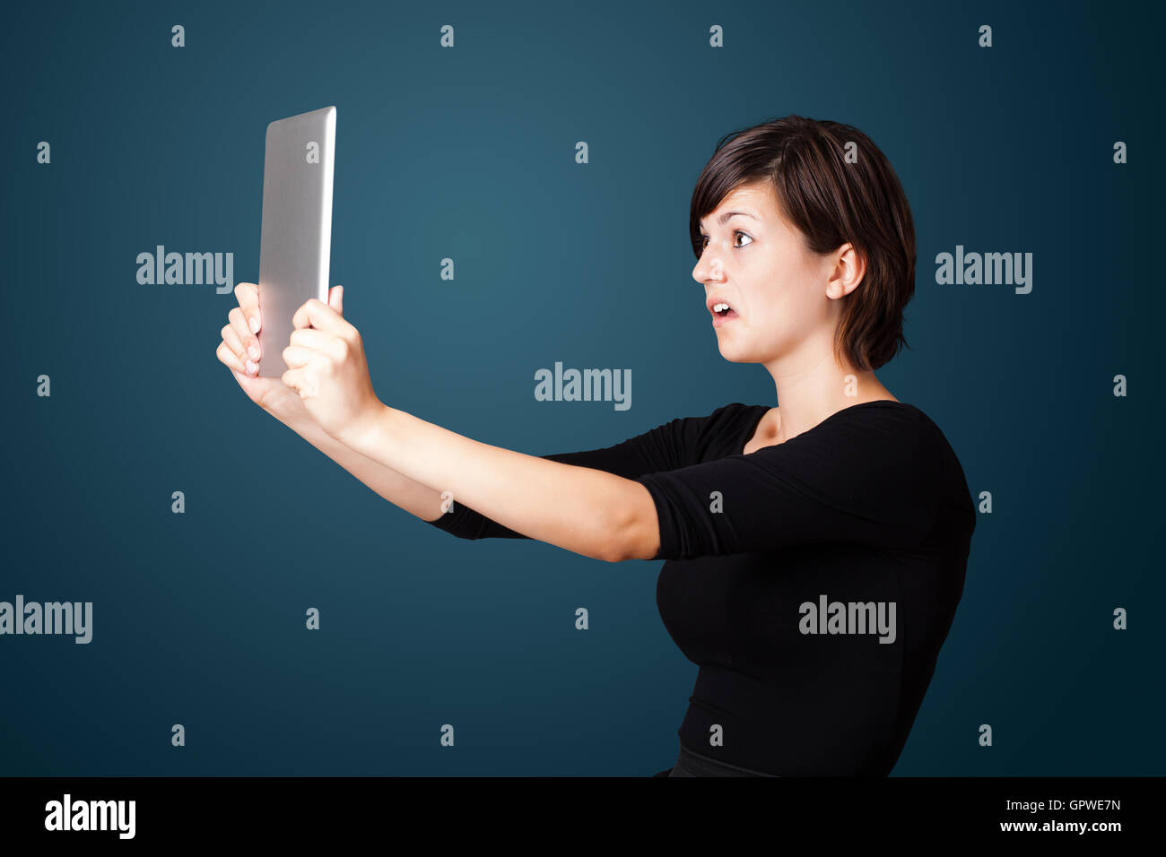 Young woman looking at modern tablet Stock Photo - Alamy