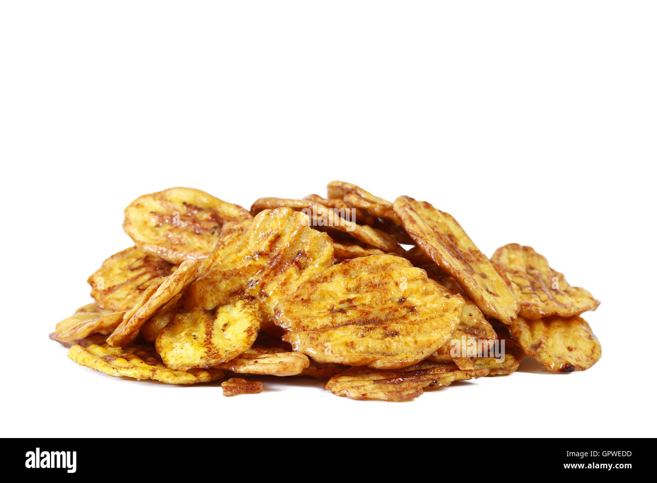 Fried thinly sliced banana chips, a tropical snack Stock Photo - Alamy