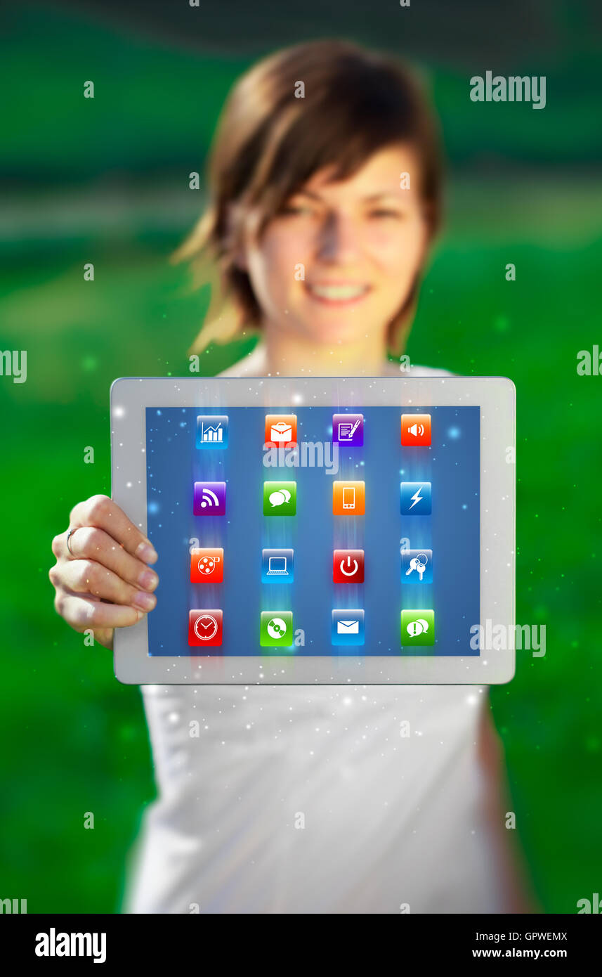Young woman looking at modern tablet with abstract lights and va Stock ...