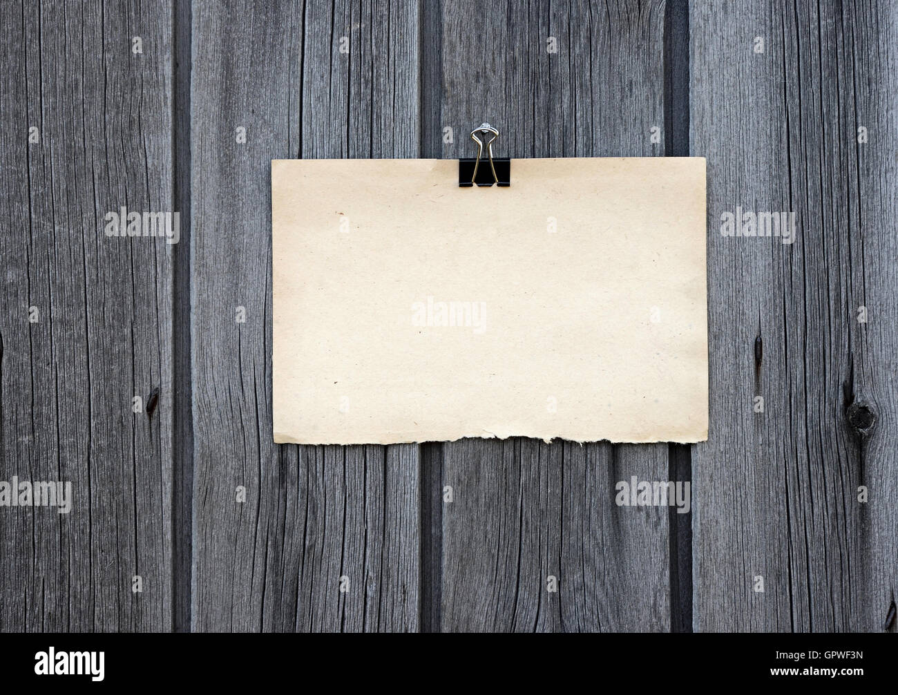 black clip and old blank note paper hang on wood panel Stock Photo - Alamy