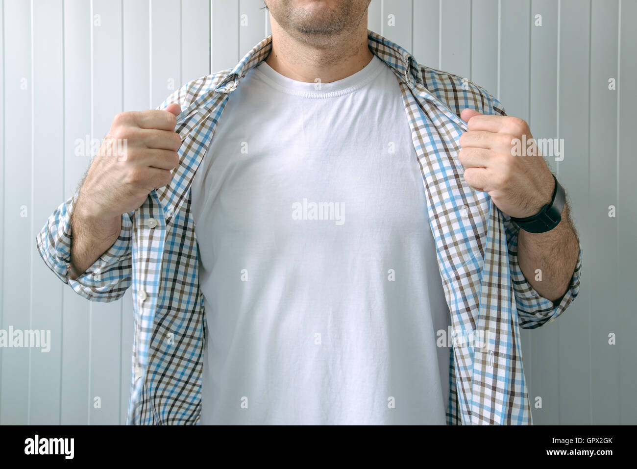 Guy revealing white t-shirt as copy space for mock up graphic design ...