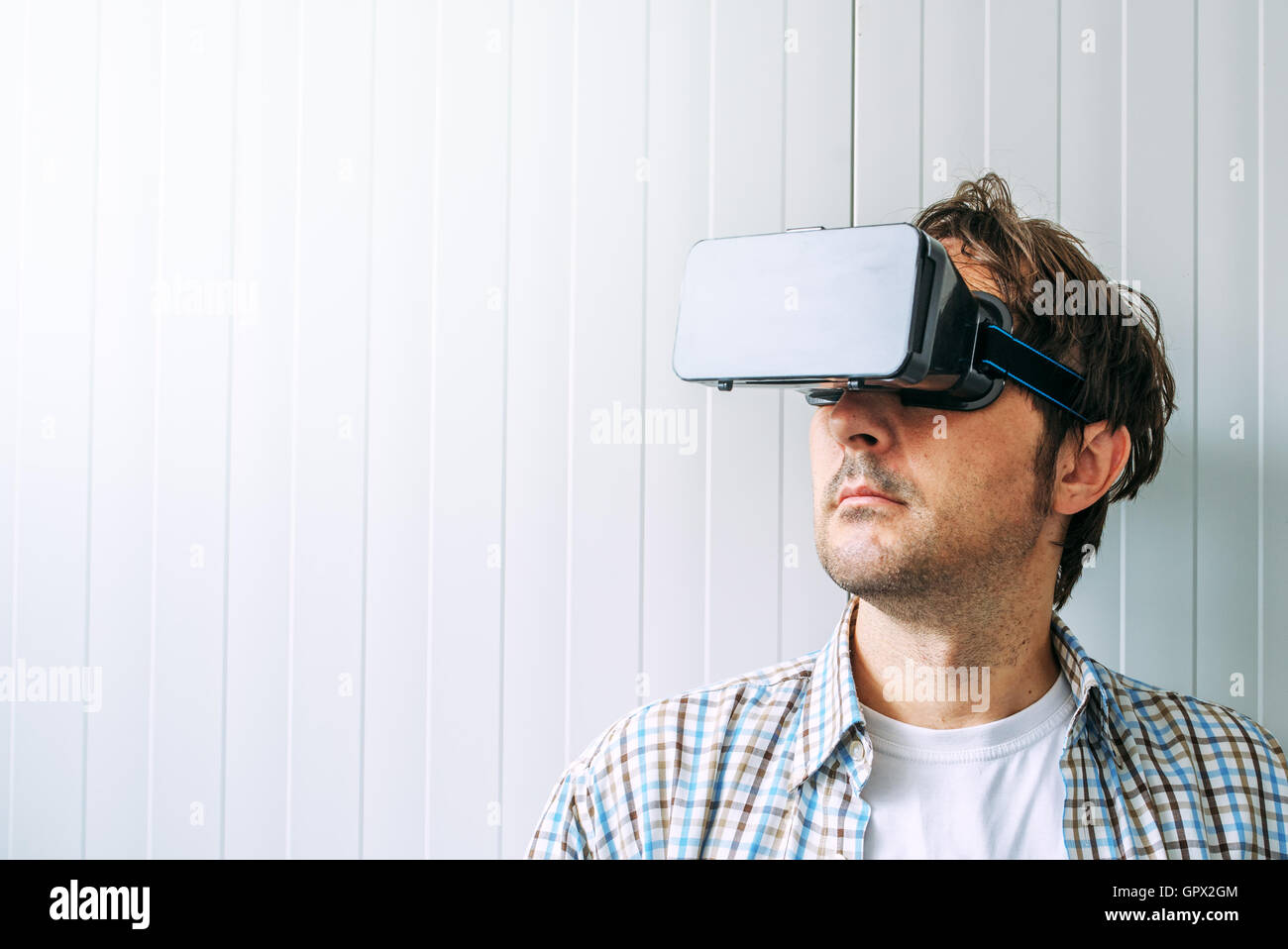 Man with VR headset goggles viewing realistic 3d virtual reality ...