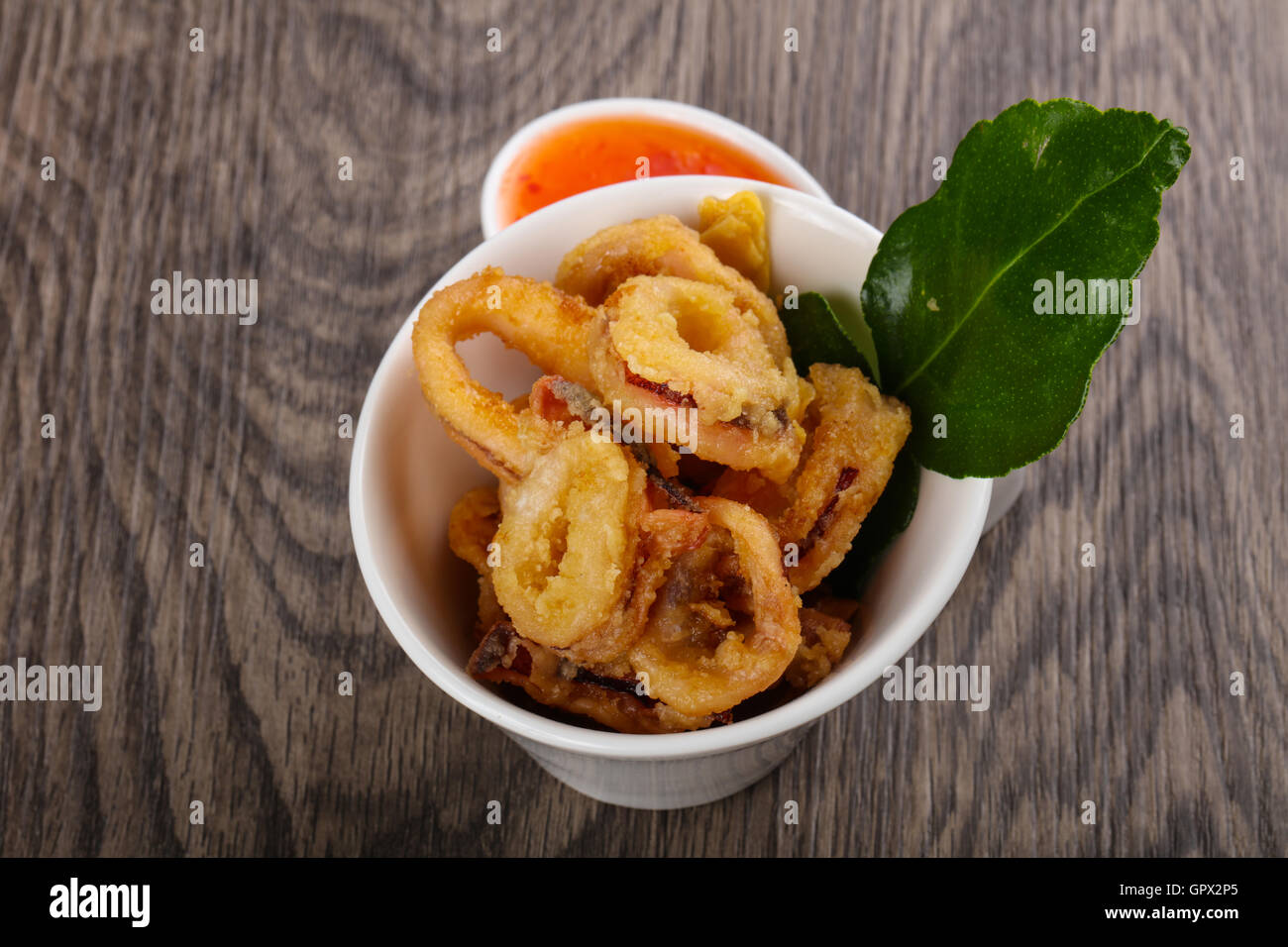 Fried squid rings with hot spicy sauce Stock Photo - Alamy