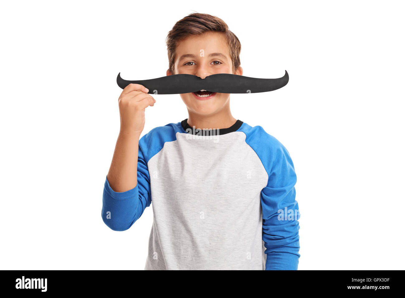 Happy kid posing with a fake moustache isolated on white background ...