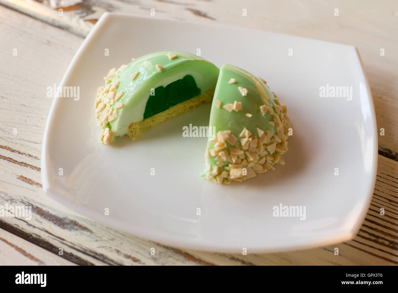 Small green cake with filling Stock Photo - Alamy