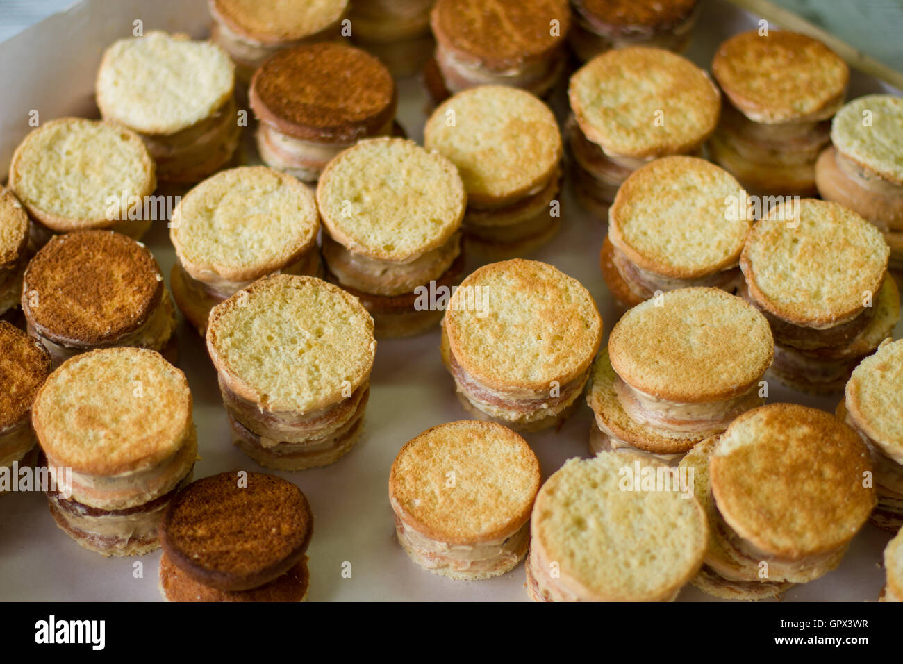 Sandwich cookies of yellow color Stock Photo - Alamy