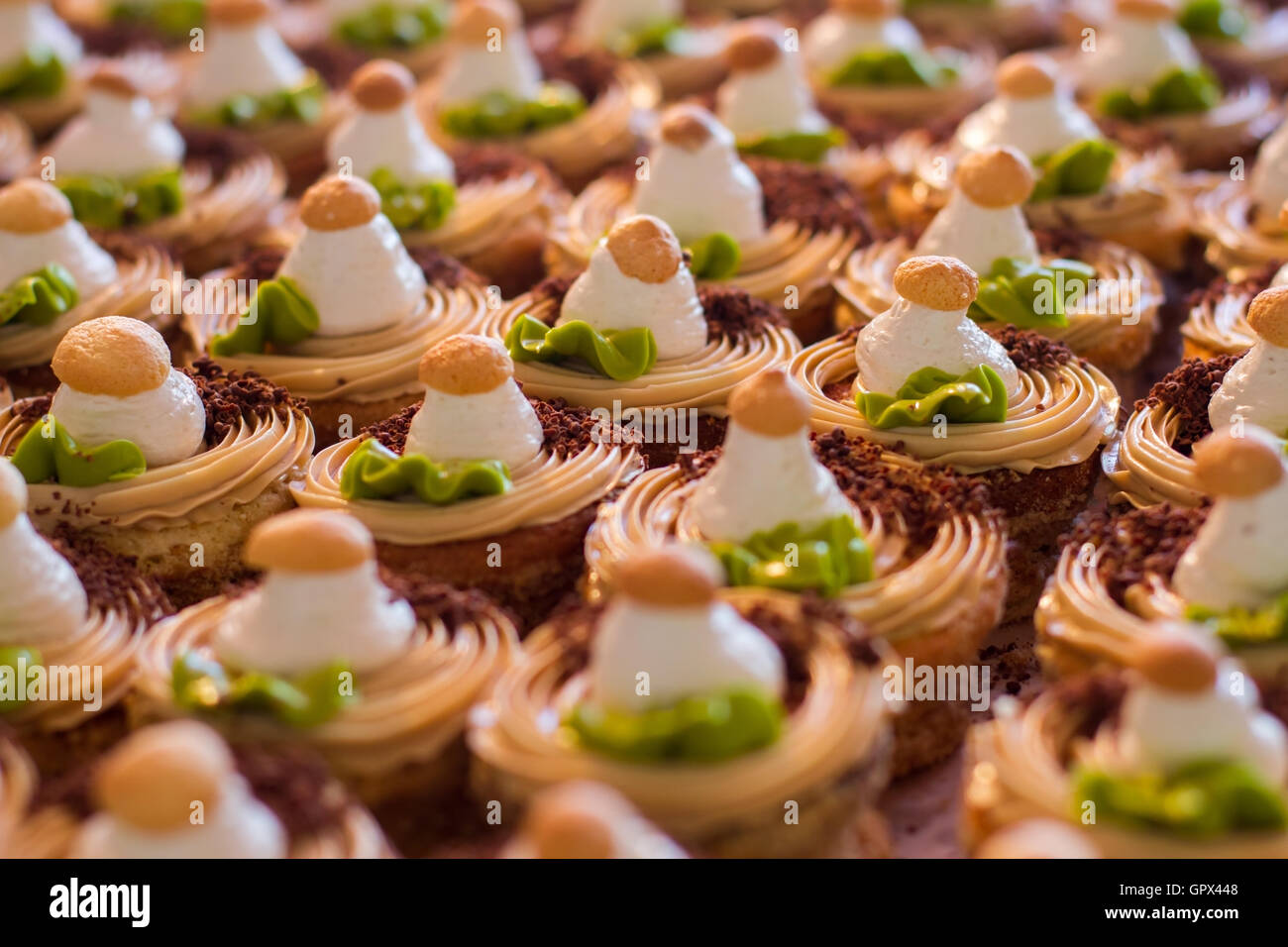 Rows of small decorated cakes Stock Photo - Alamy