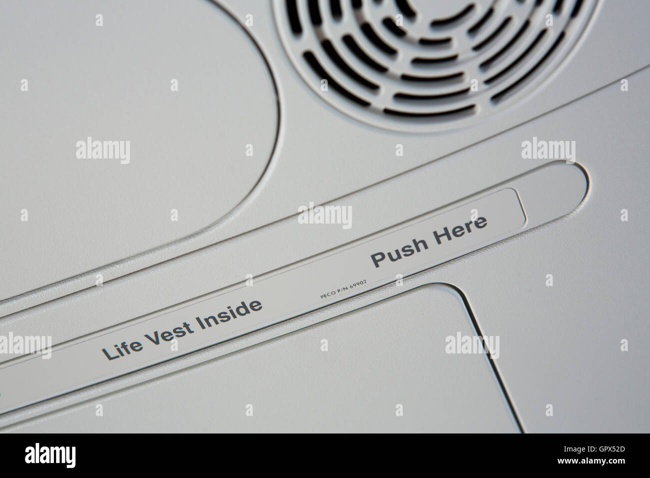 Overhead botton to release life jacket in an aeroplane Stock Photo - Alamy