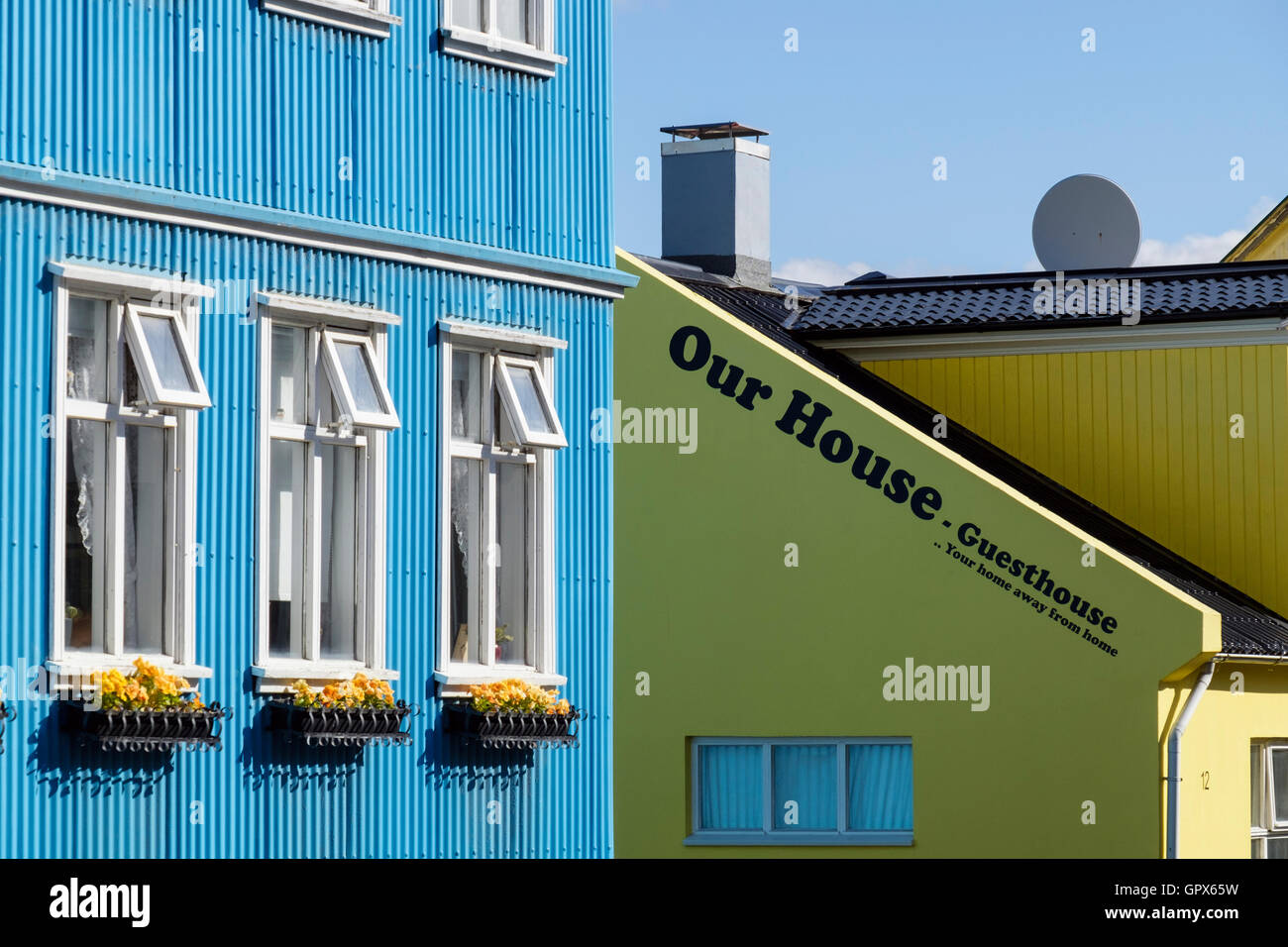 Yellow guesthouse and colourful blue building with corrugated walls ...