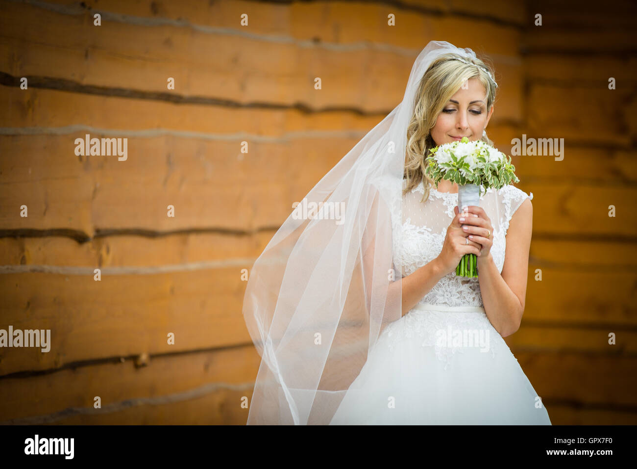Gorgeous bride on her wedding day holding her lovely bouquet (color ...