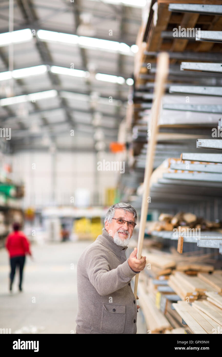 Man choosing and buying construction wood in a DIY store for his DIY ...