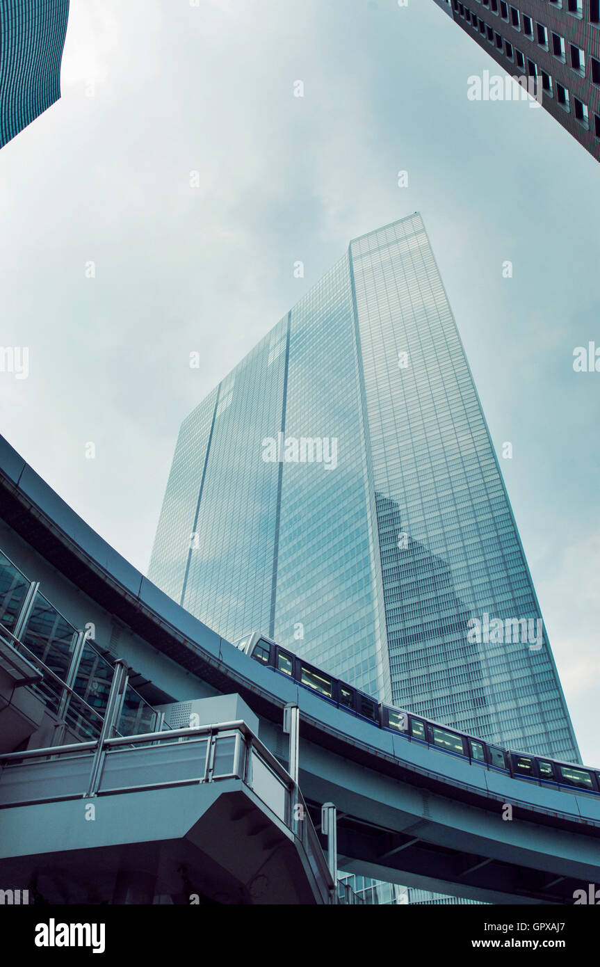 cars of moving train on hanged railway structure between huge ...