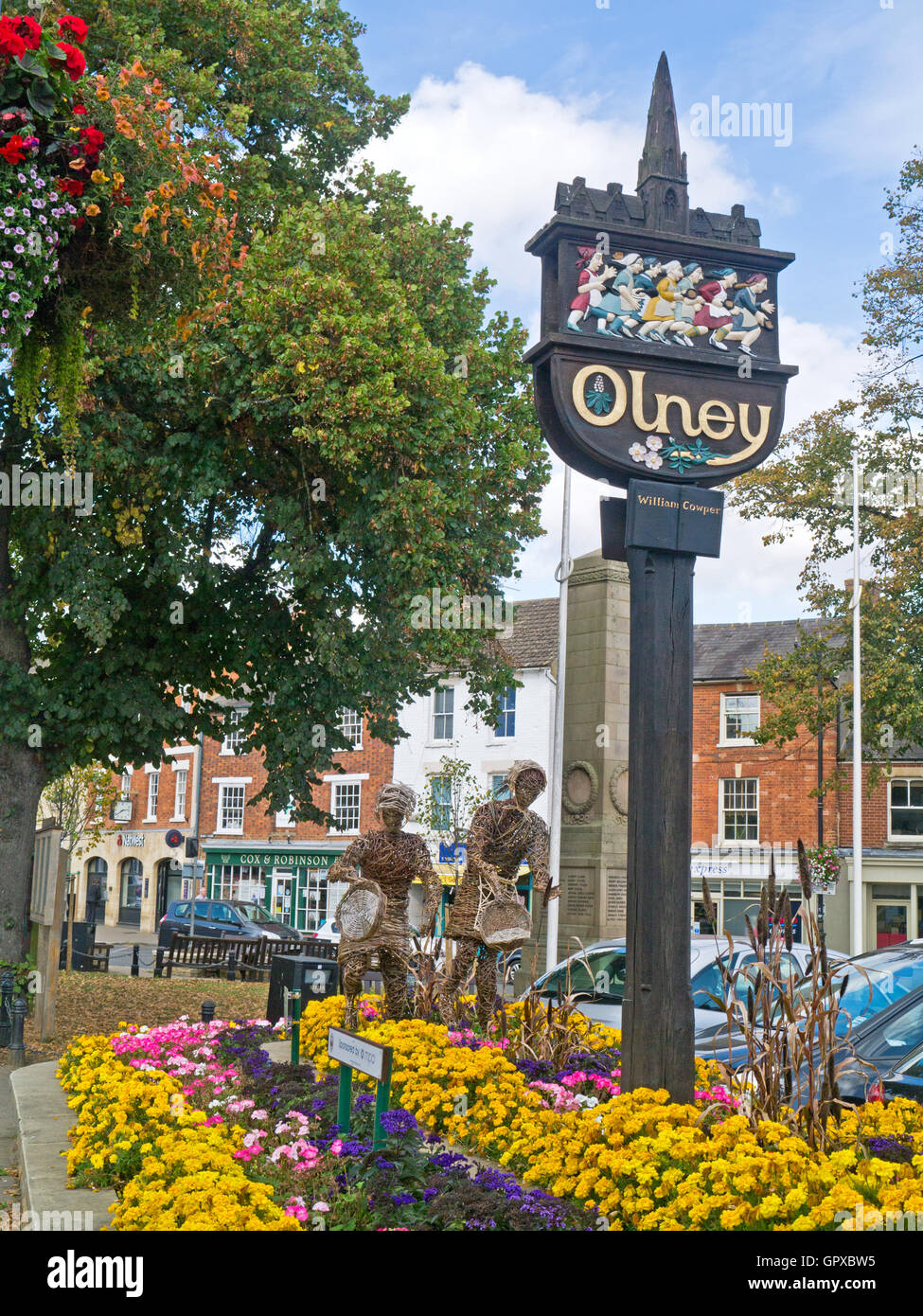 Sign for the market town of Olney, including figures depicting the town ...