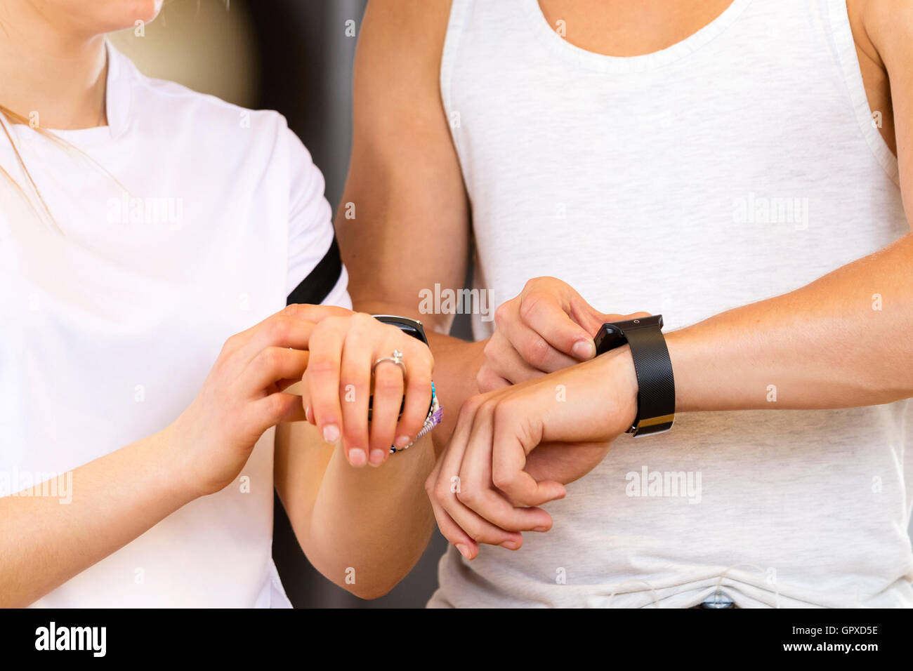 Two people using smart sport watch at workout Stock Photo - Alamy