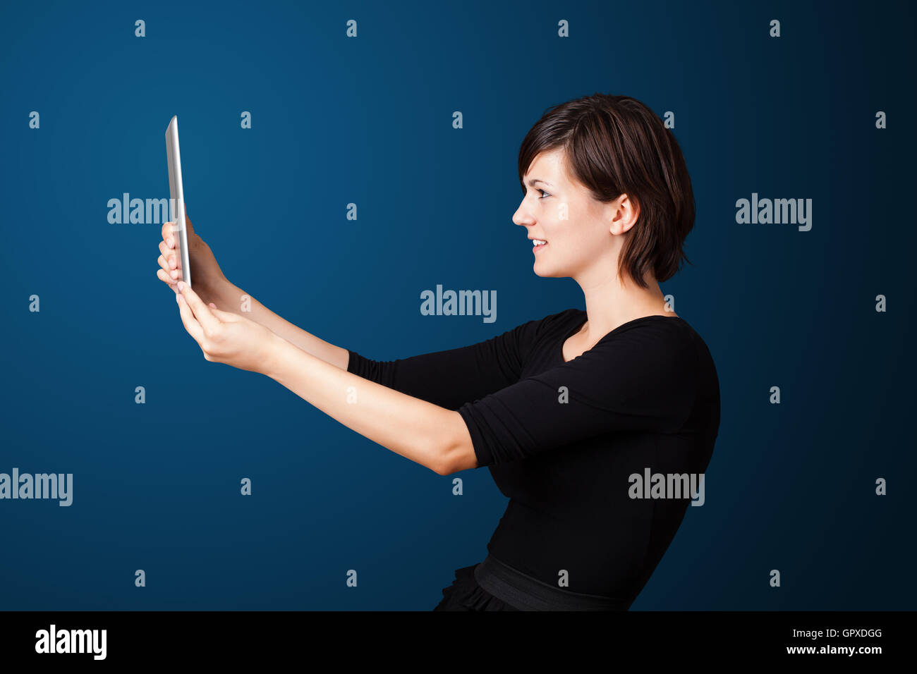 Young woman looking at modern tablet Stock Photo - Alamy