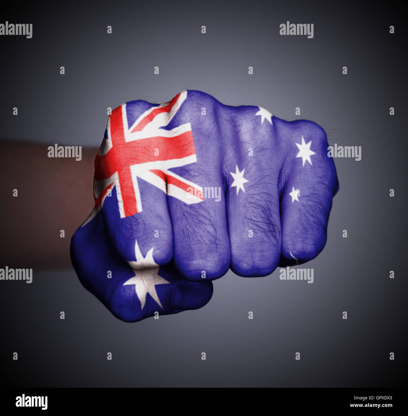 Front view of punching fist on gray background Stock Photo - Alamy