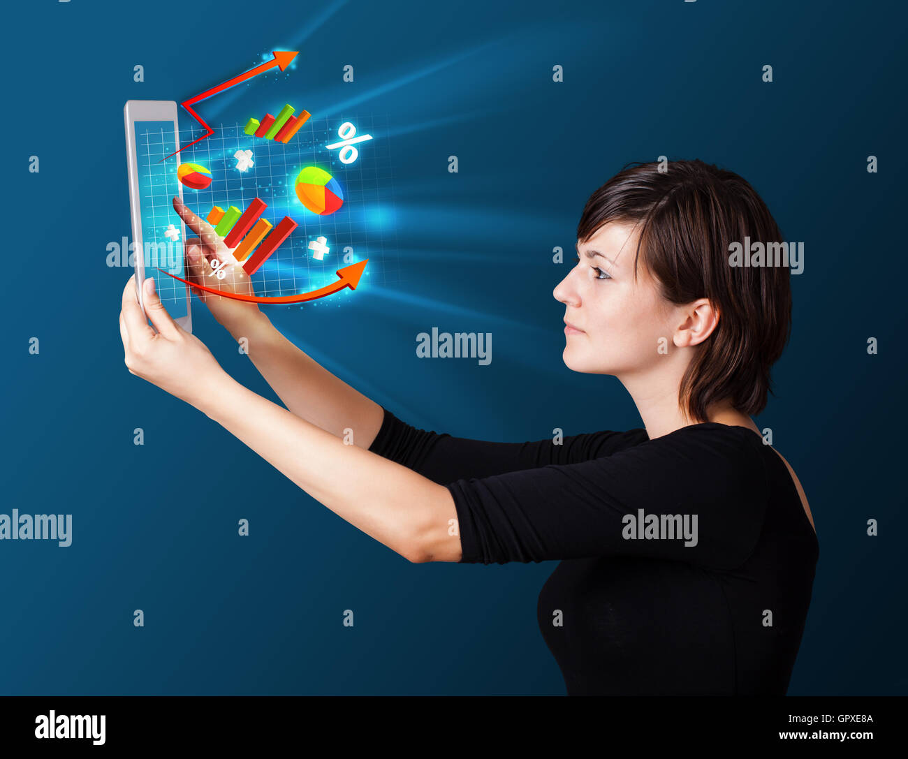 Young woman looking at modern tablet with abstract lights and va Stock ...