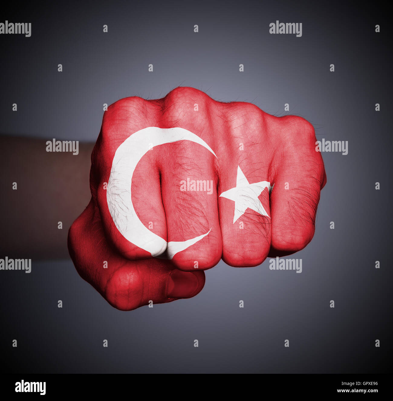 Front view of punching fist on gray background Stock Photo - Alamy