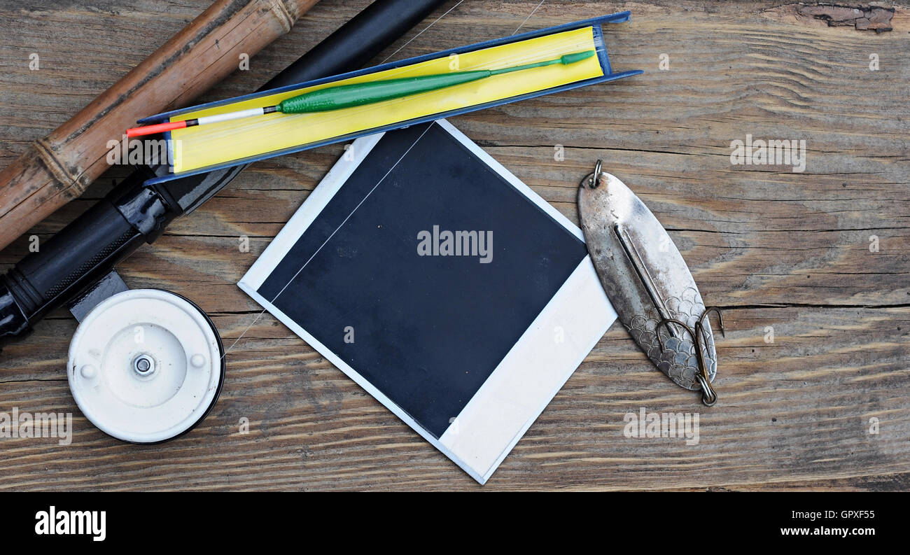Fly fishing rod with photo frame on wood background Stock Photo - Alamy