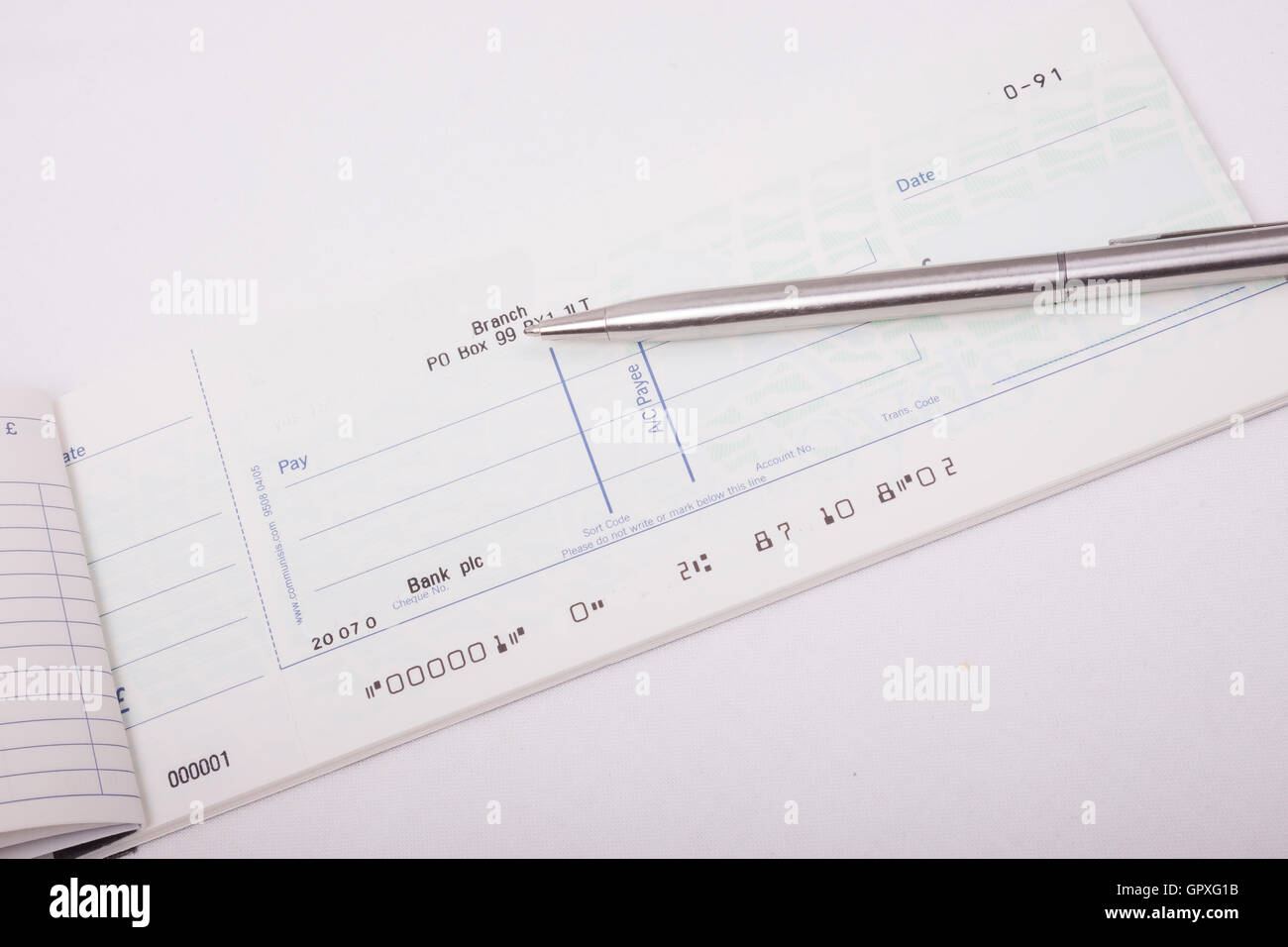 Check book and pen Stock Photo - Alamy