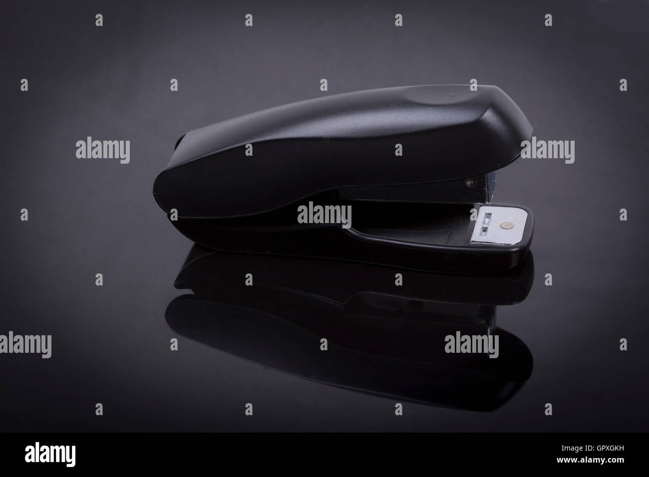 photo of a stapler on a black shiny background Stock Photo - Alamy