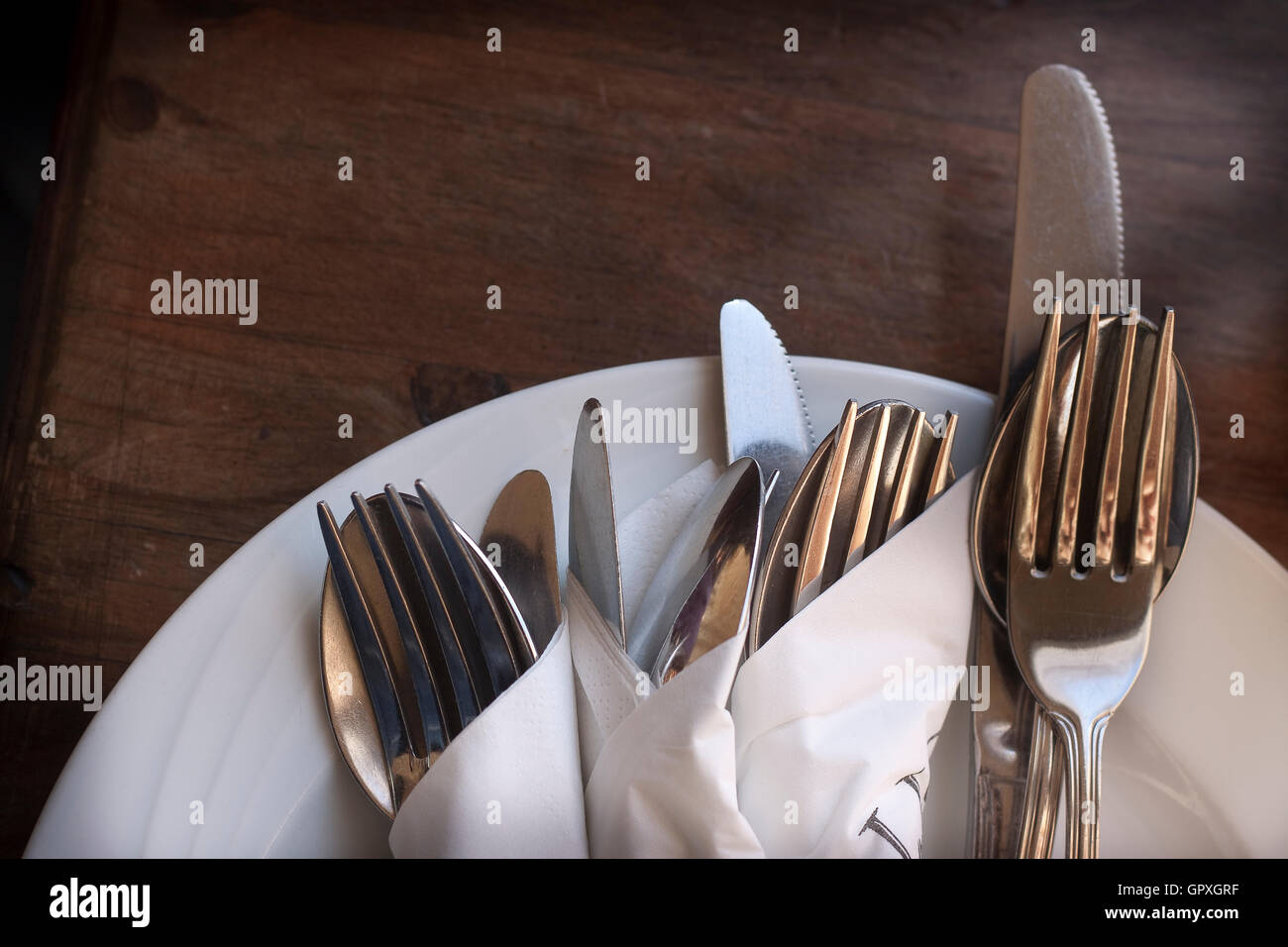 Cutlery on plate Stock Photo - Alamy