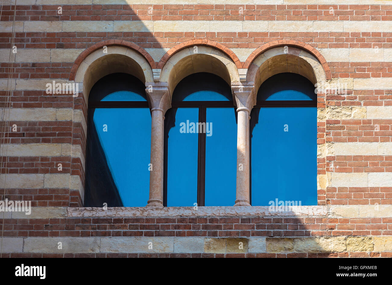 exterior of an old building with arched windows Stock Photo - Alamy