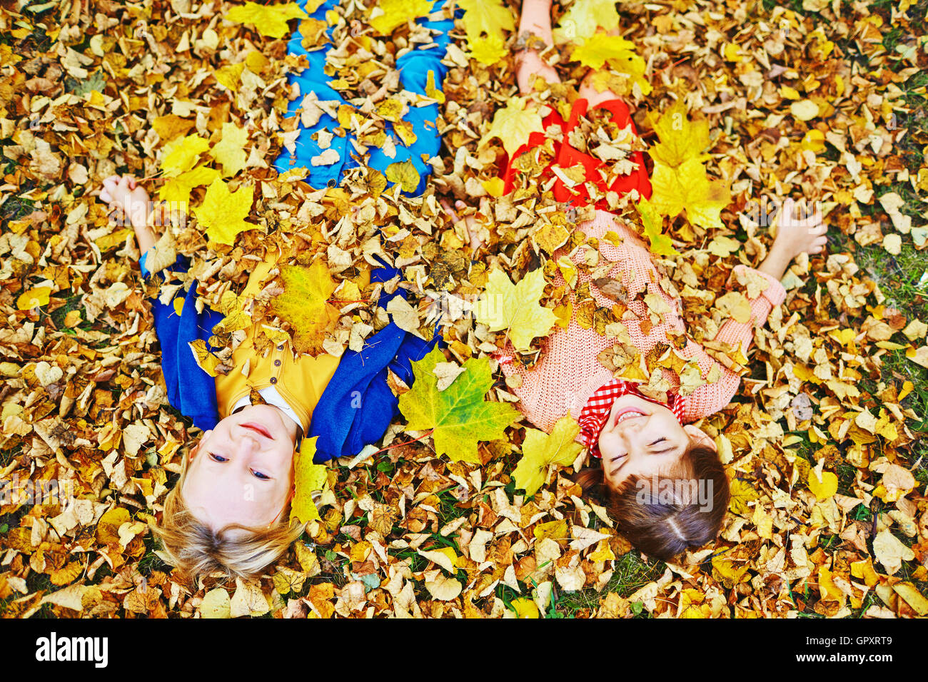Kids in pile of leaves hi-res stock photography and images - Alamy