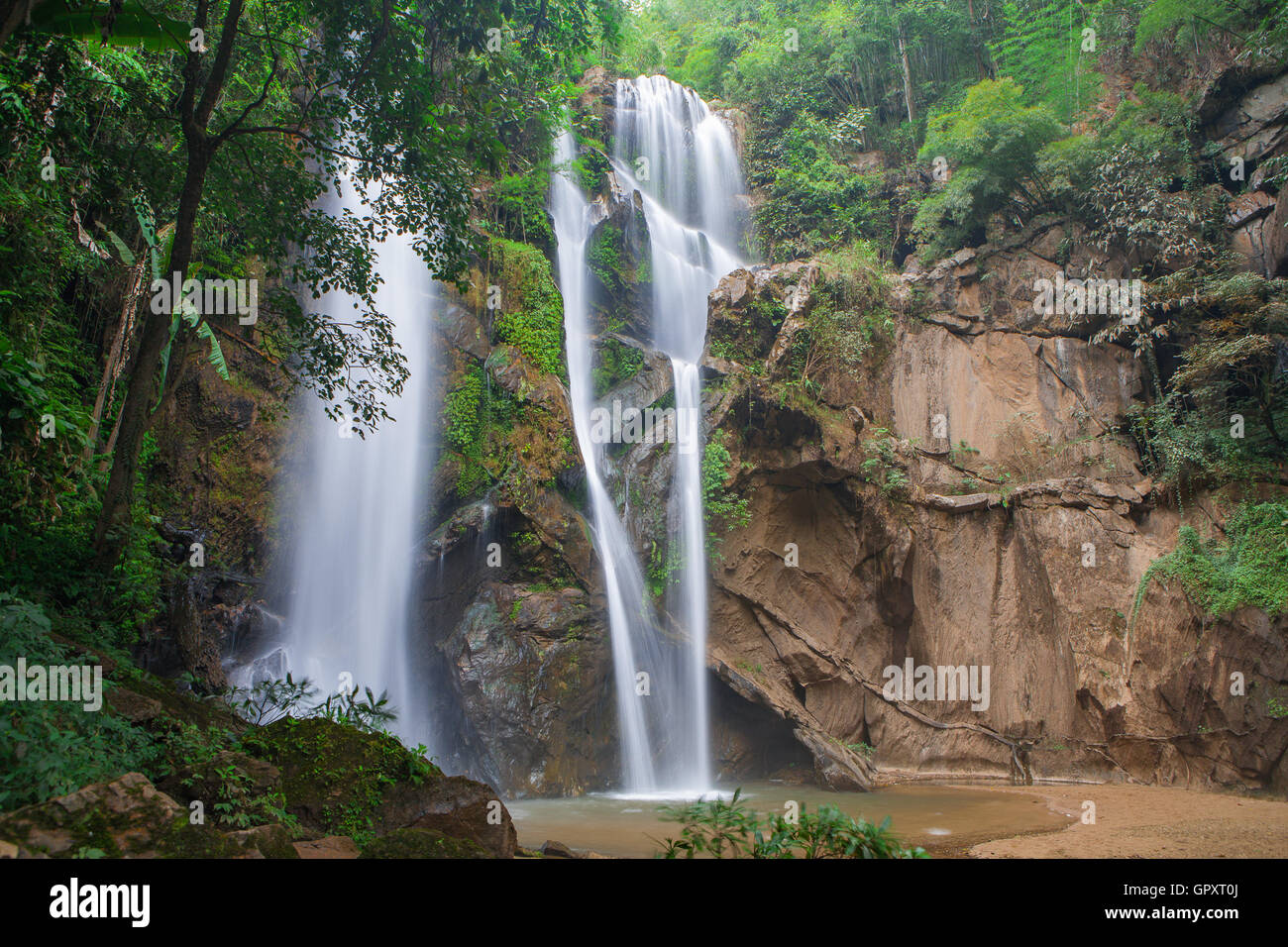Gently fallen water of Mok Fah waterfall amidst lush jungle, Chiang Mai ...