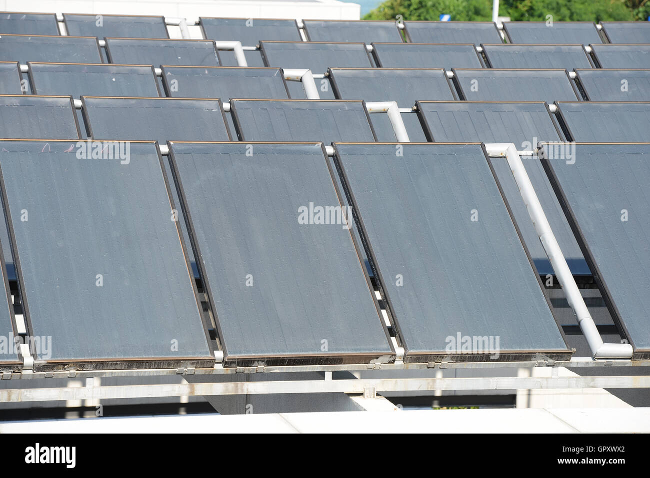 Solar water heating panel on a house roof Stock Photo - Alamy