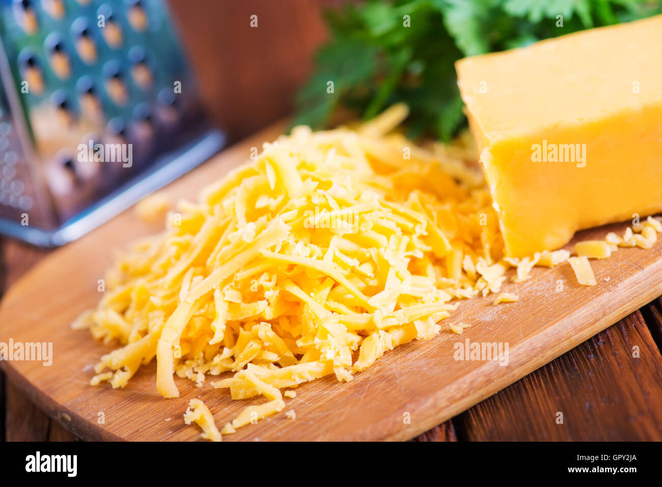 cheddar cheese on board and on a table Stock Photo - Alamy