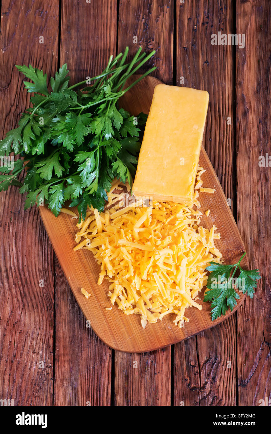 cheddar cheese on board and on a table Stock Photo - Alamy
