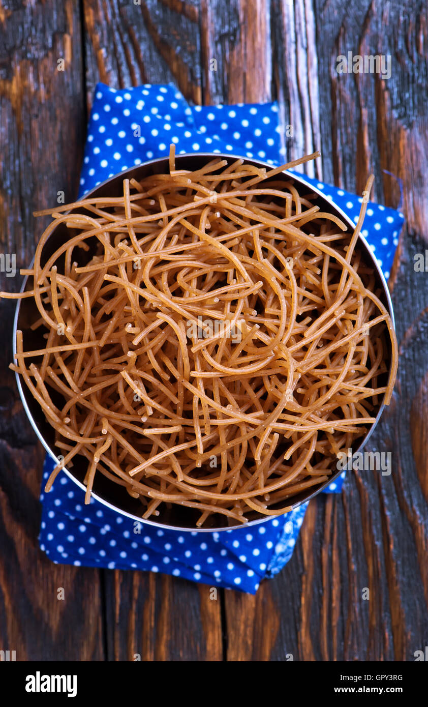 brown pasta in bowl and on a table Stock Photo - Alamy