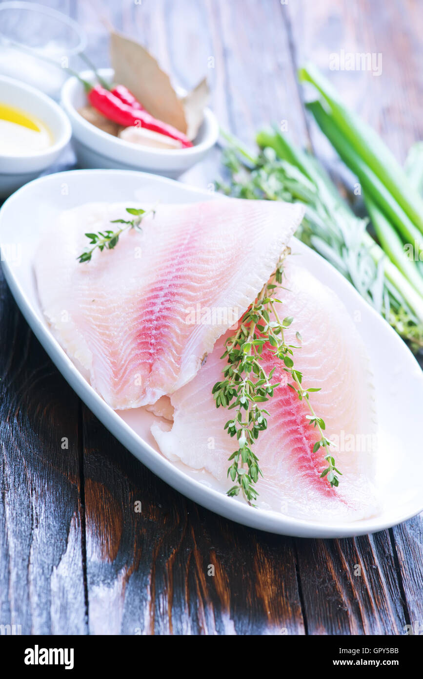 fish fillet on plate and on a table Stock Photo - Alamy