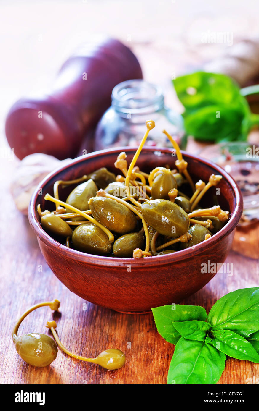 capers in bowl and on a table Stock Photo - Alamy
