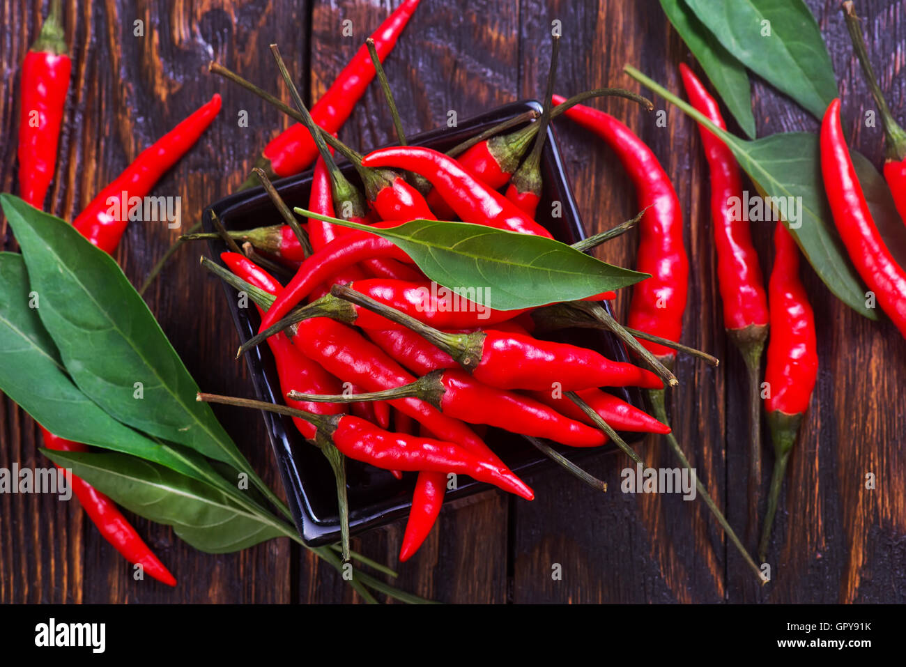 red hot chilli peppers on a table Stock Photo - Alamy