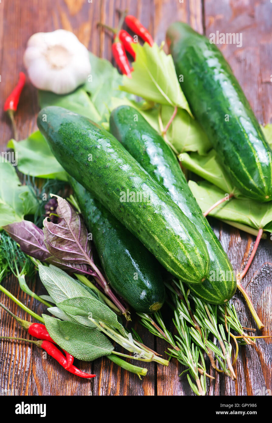fresh cucumbers with salt and spice on the wooden table Stock Photo - Alamy