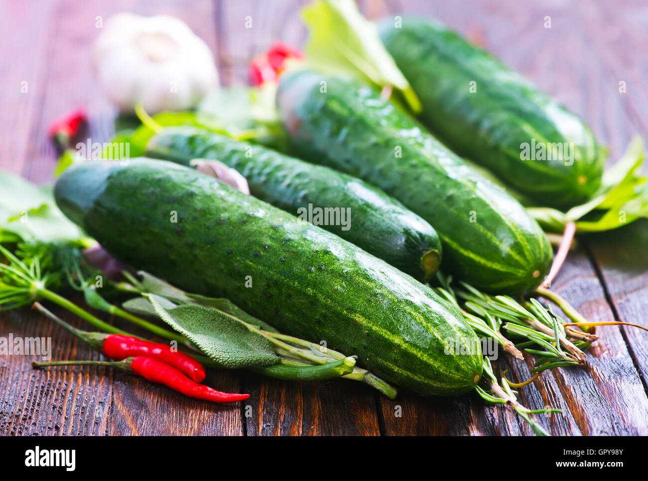 fresh cucumbers with salt and spice on the wooden table Stock Photo - Alamy