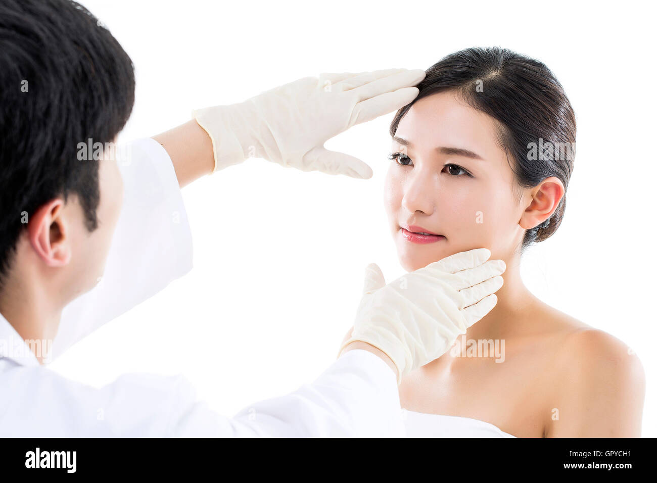 Plastic Surgery/ Doctor Examining the Face of a Young Asian Woman Stock ...