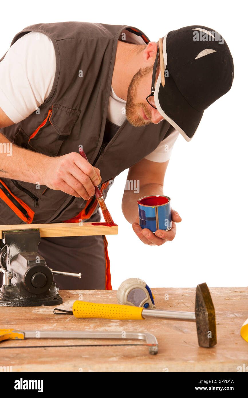 A carpenter painting wood in red color isolated over white diy Stock ...