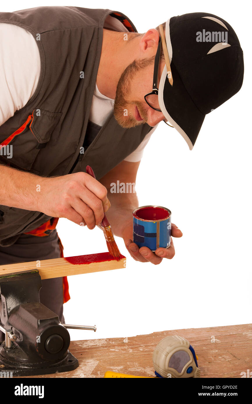 A carpenter painting wood in red color isolated over white diy Stock ...