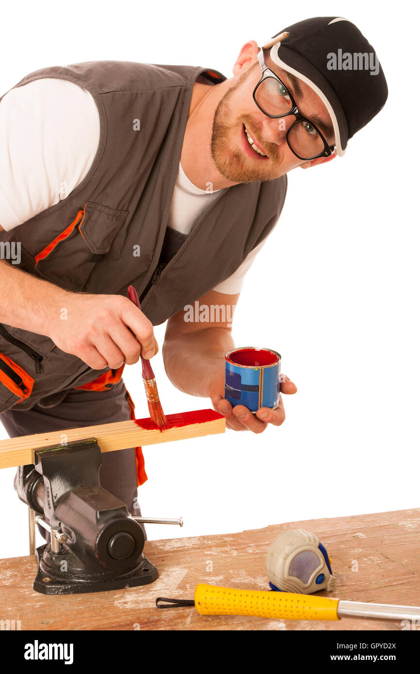 A carpenter painting wood in red color isolated over white diy Stock ...