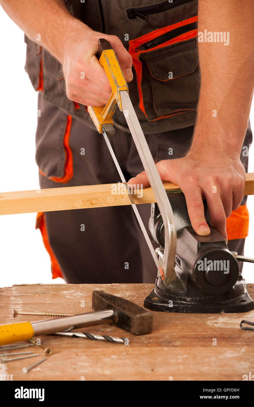 Young carpenter cuts a wooden lath with a saw isolated over white Stock ...
